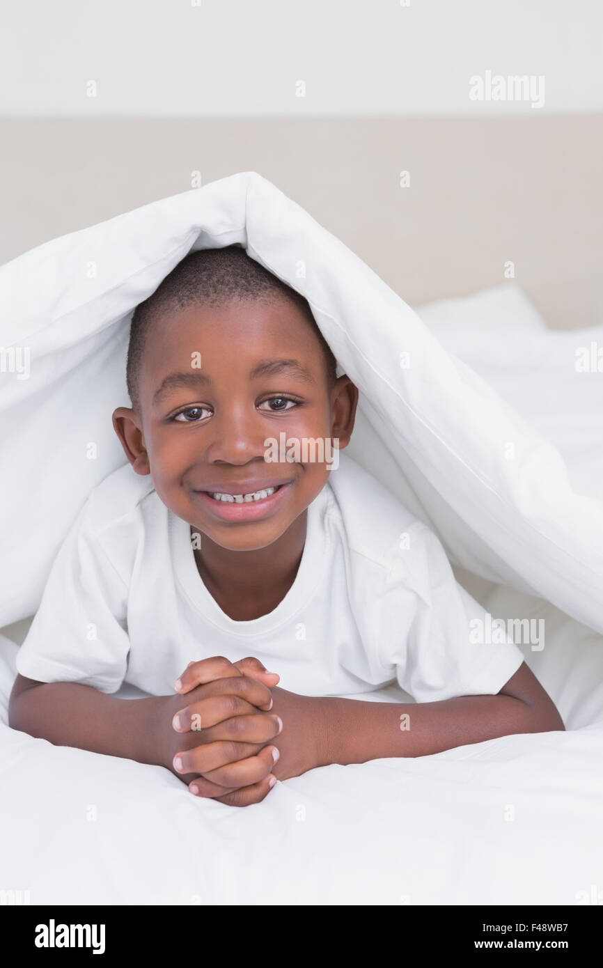 Pretty smiling little boy in bed Stock Photo - Alamy
