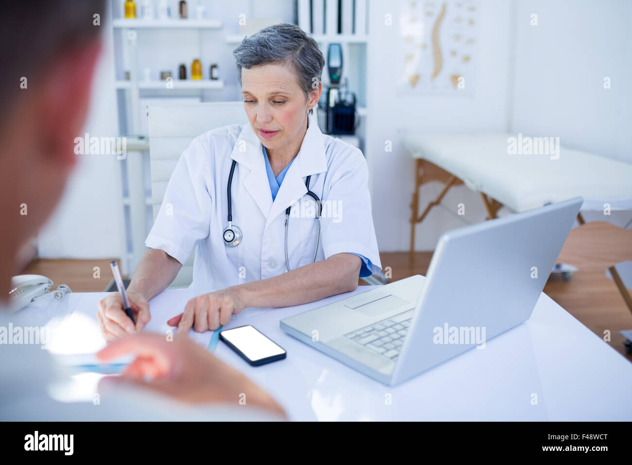 Female doctor speaking with her patient Stock Photo - Alamy