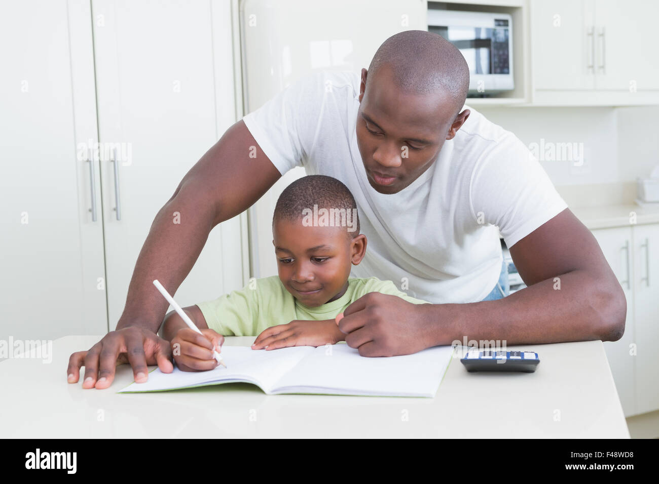 Happy smiling father working with his son Stock Photo - Alamy