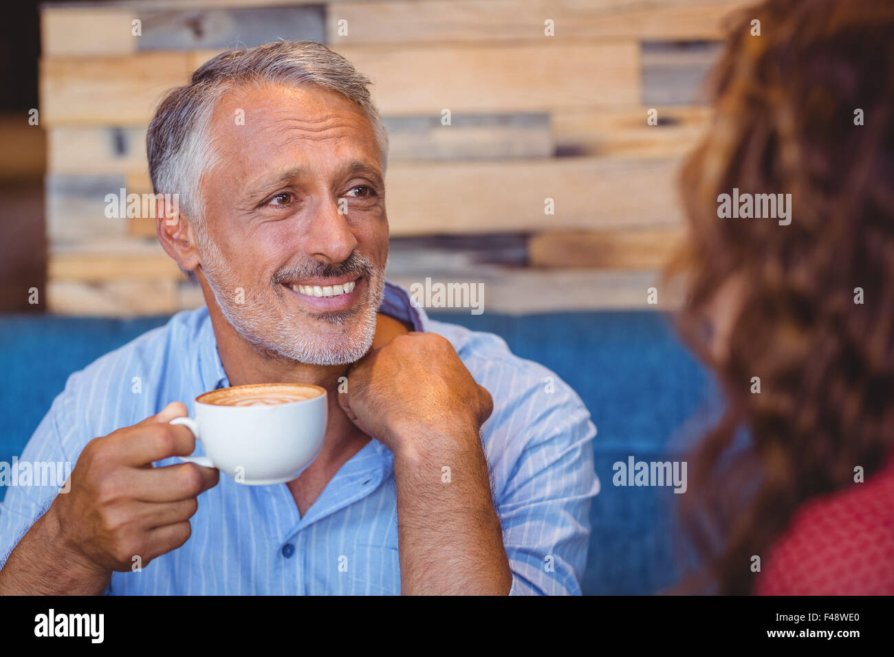 Cute couple having coffee together Stock Photo - Alamy