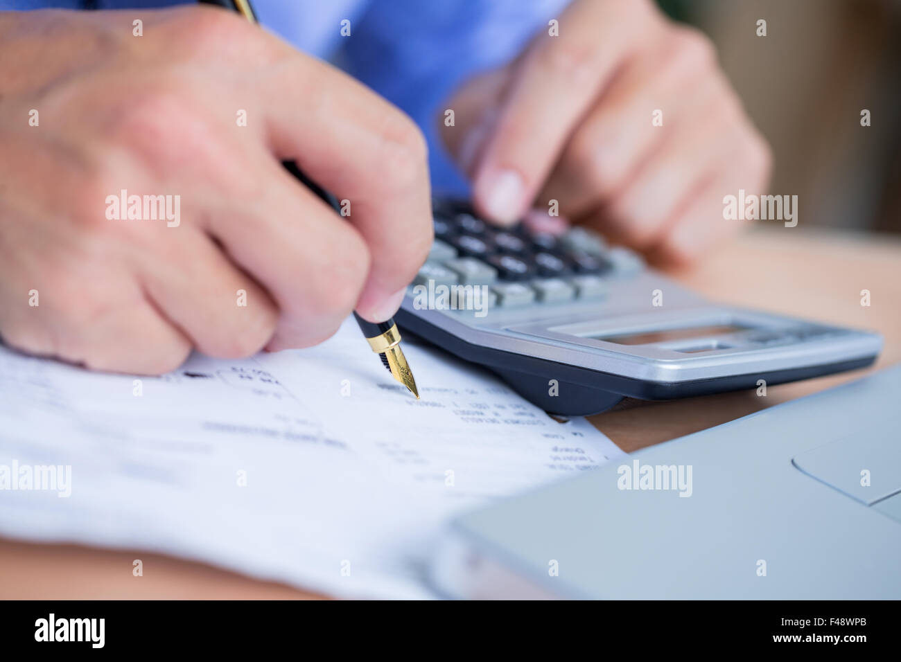 Close up hands using the calculator Stock Photo - Alamy
