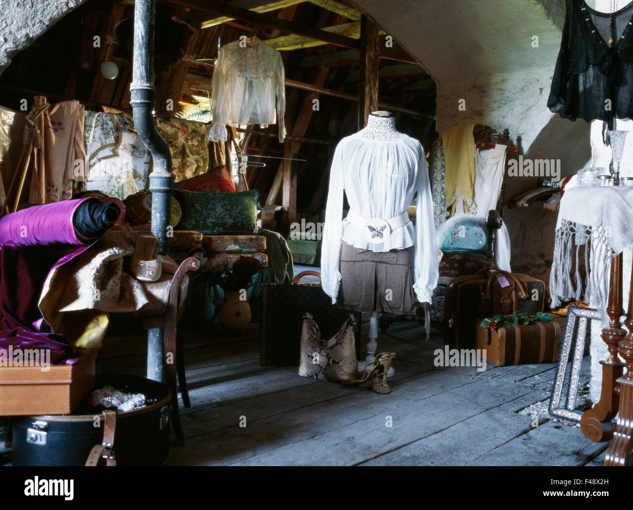 A attic with clothes and bags Stock Photo - Alamy