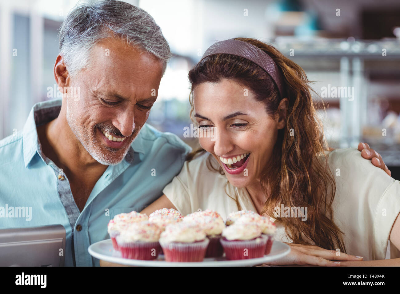 Cute couple looking at cakes Stock Photo - Alamy