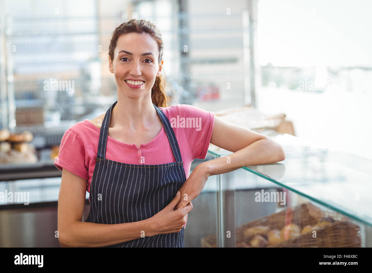 Pretty waitress leaning on counter Stock Photo - Alamy