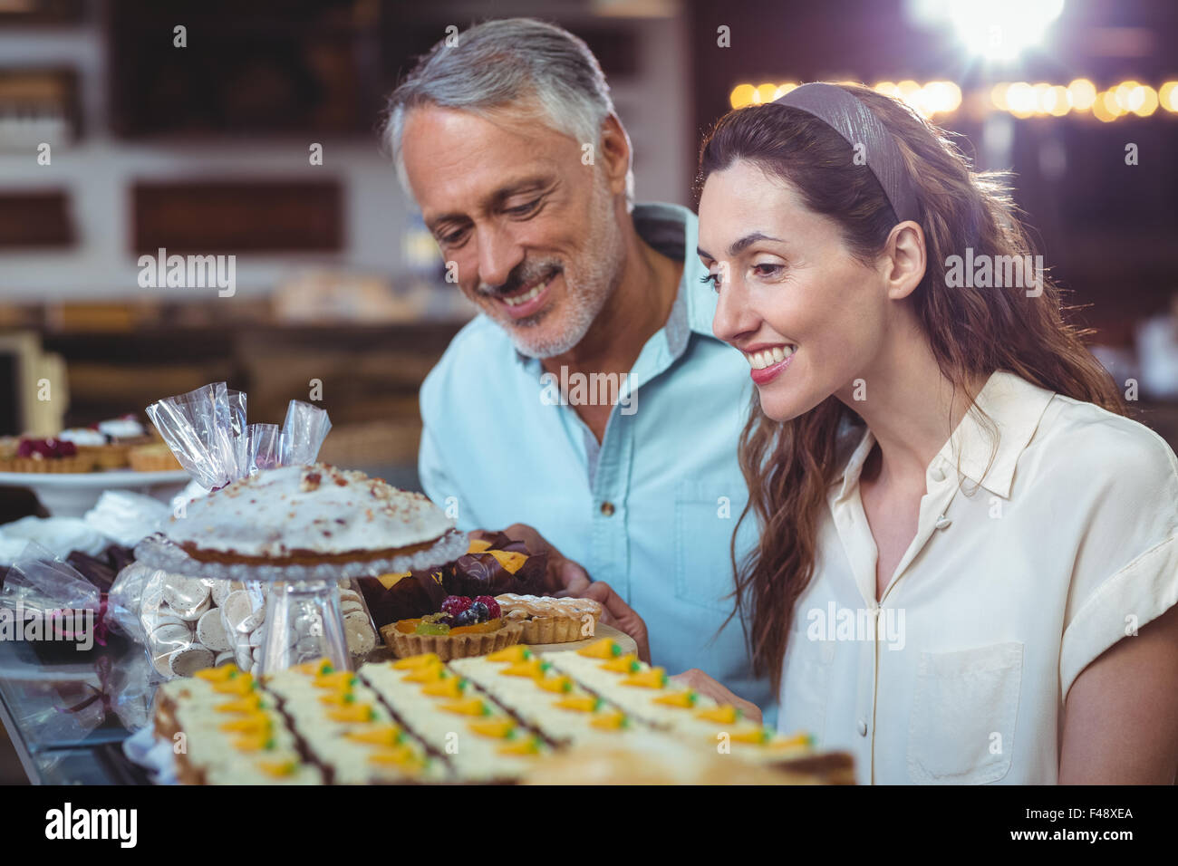 Cute couple looking at cakes Stock Photo - Alamy