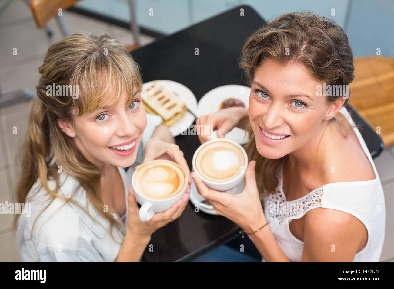 Beautiful women talking and looking at camera Stock Photo - Alamy