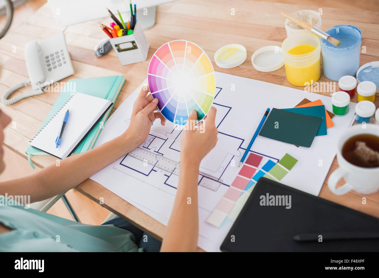 Creative businesswoman holding a color watch Stock Photo - Alamy