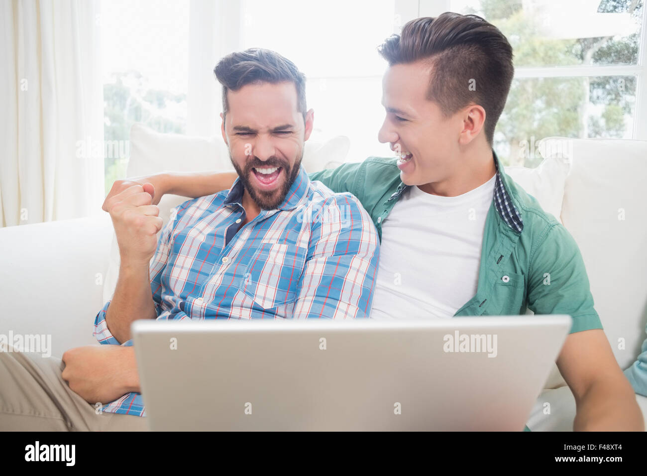Happy gay men couple using hi-res stock photography and images - Alamy