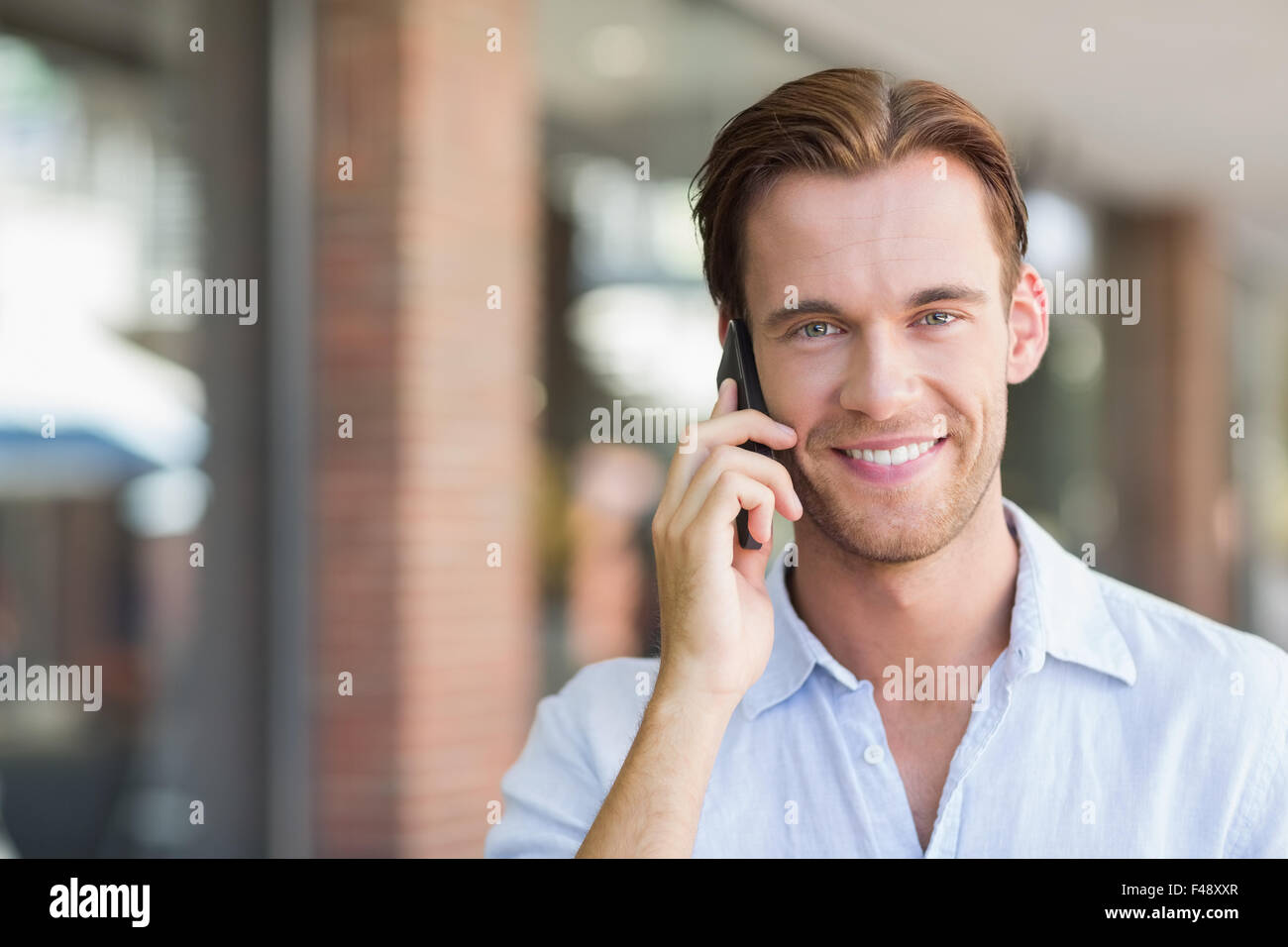 A happy smiling man calling Stock Photo - Alamy