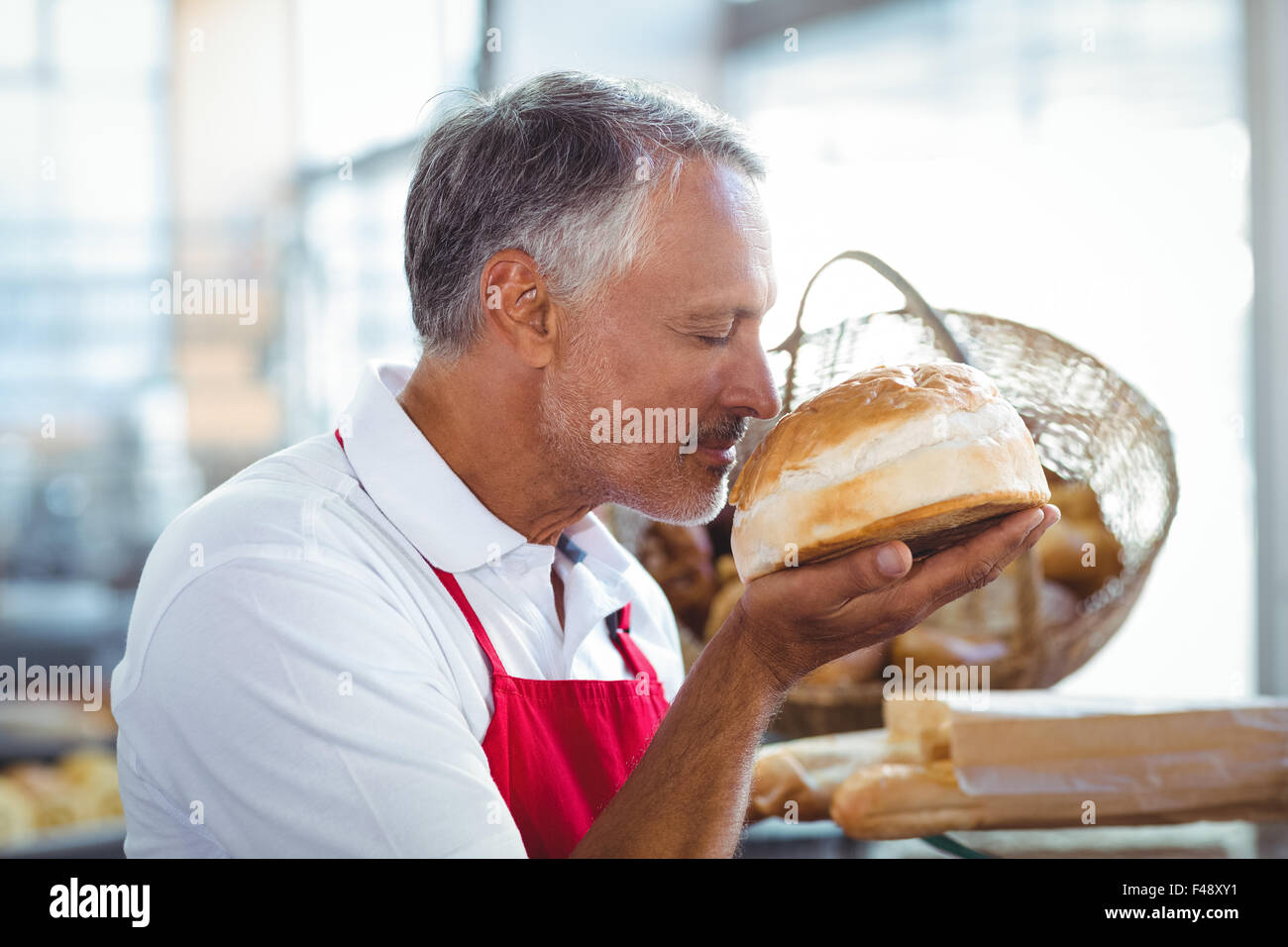 Waiter smelling freshly baked bread Stock Photo - Alamy