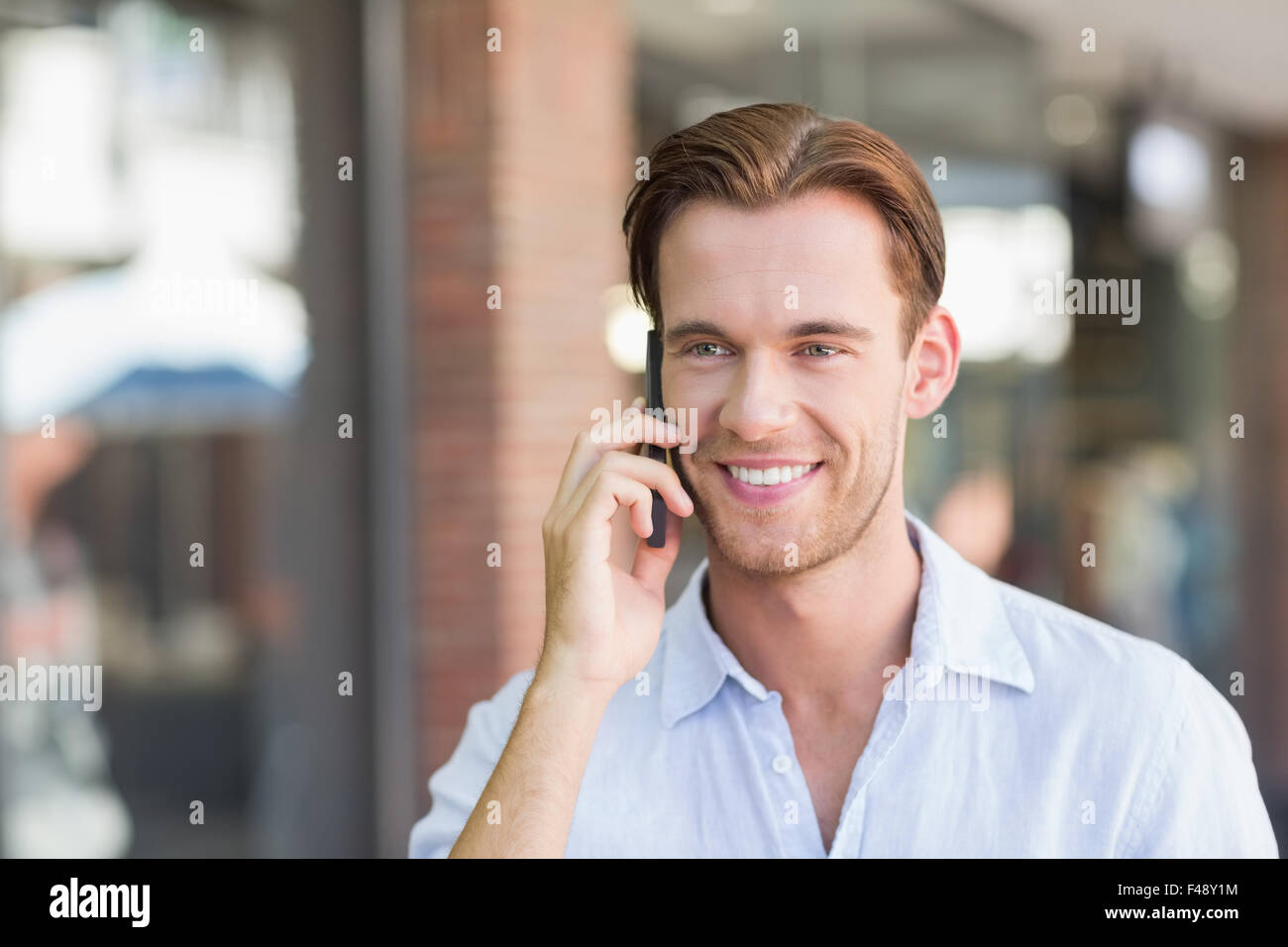 A happy smiling man calling Stock Photo - Alamy