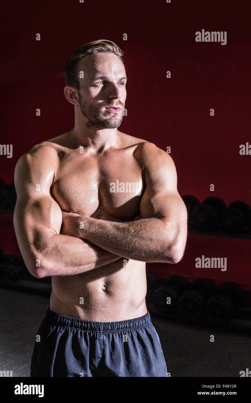 Muscular man with arms crossed Stock Photo - Alamy