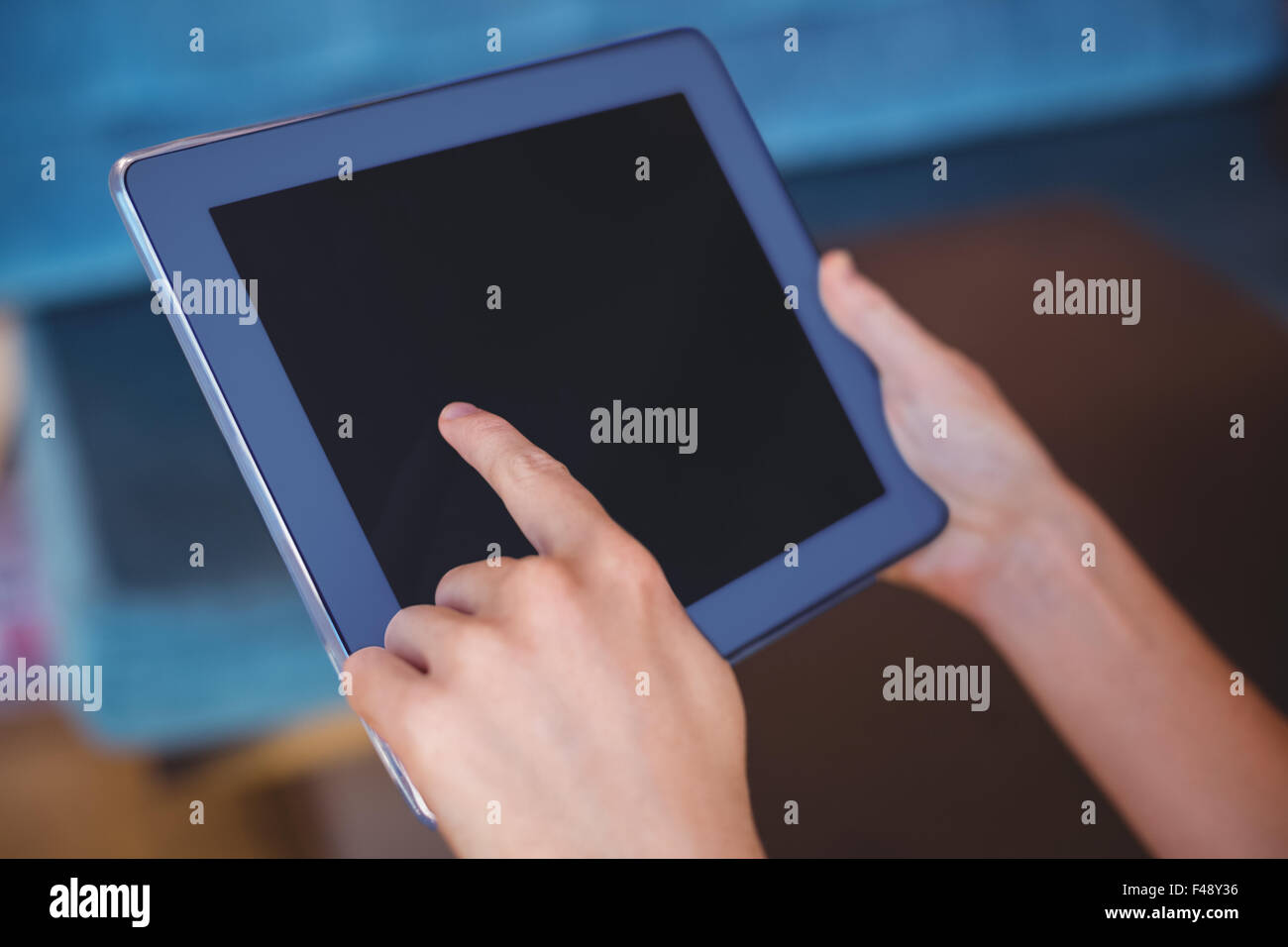 Pretty girl using a small tablet at table Stock Photo - Alamy