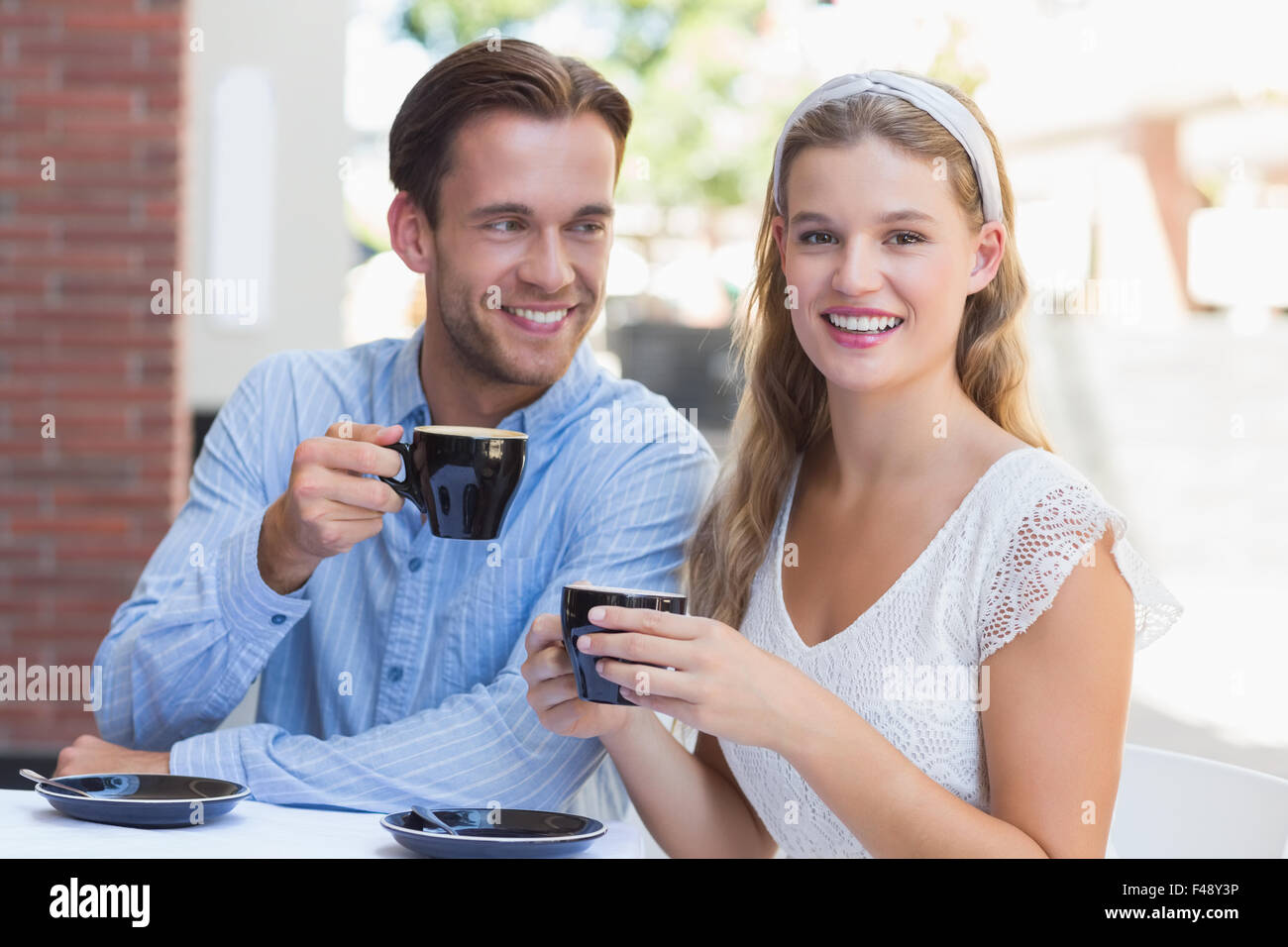Cute couple drinking a coffee together Stock Photo - Alamy
