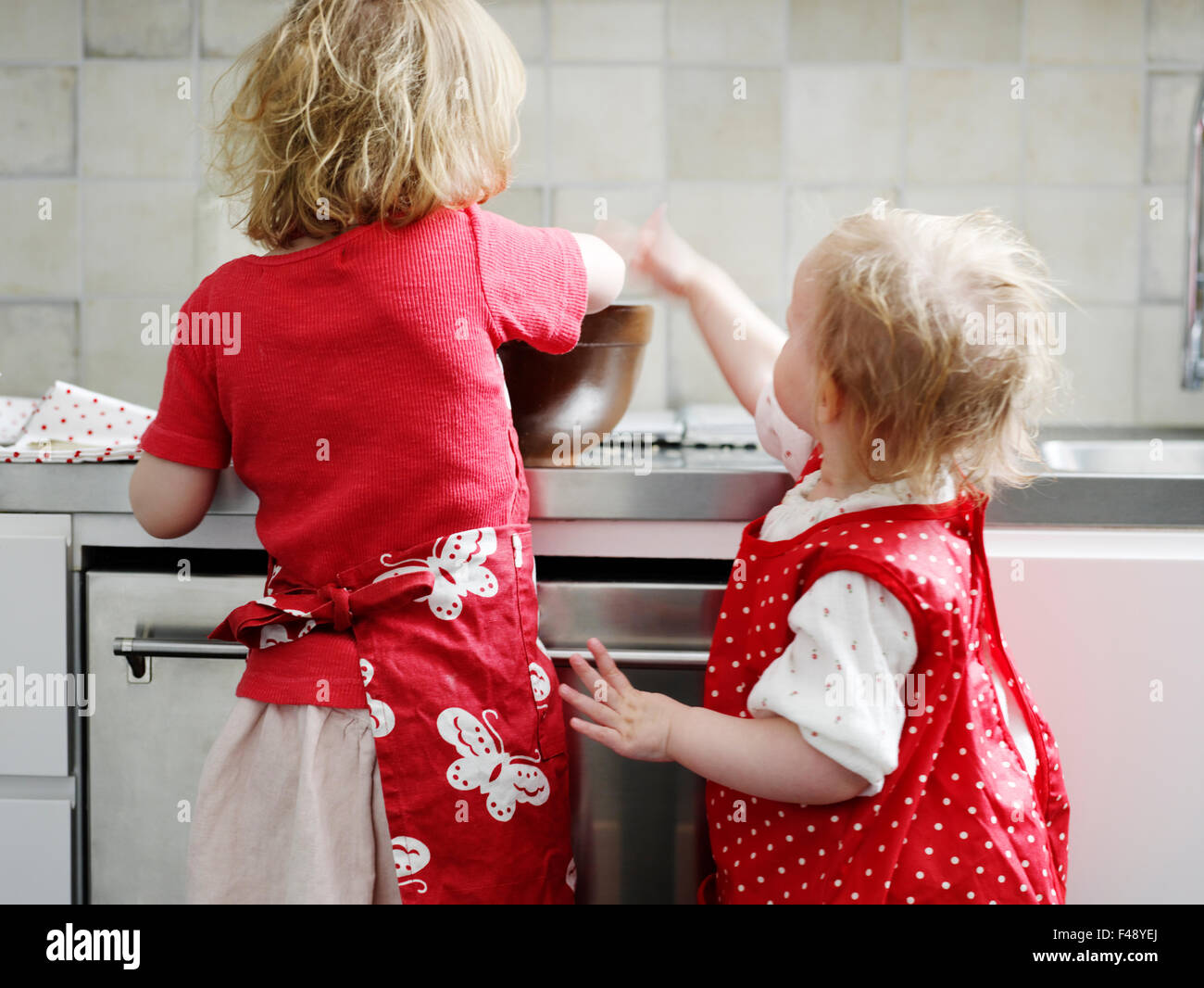 Two girls baking at christmas Stock Photo - Alamy