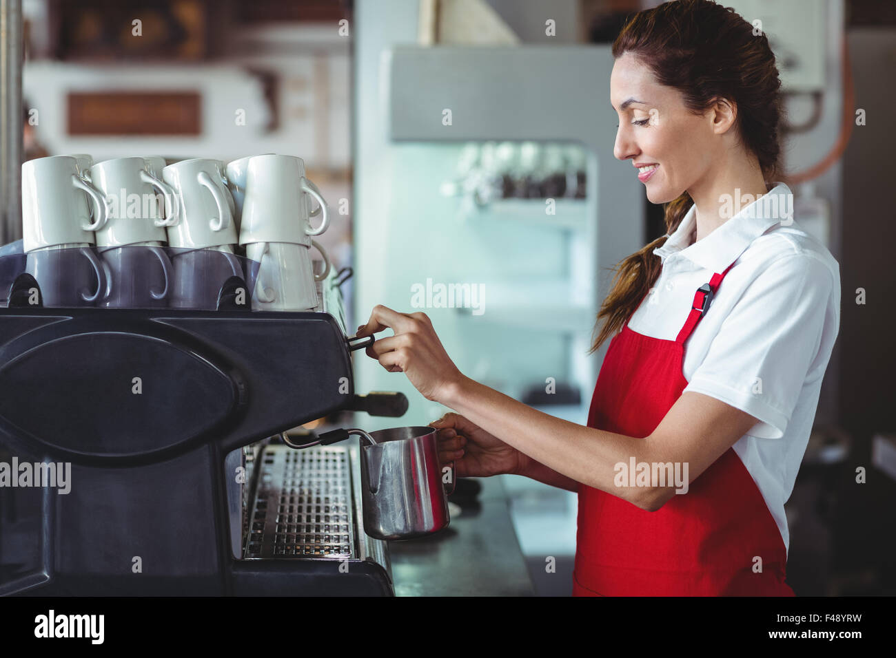 Pretty barista using the coffee machine Stock Photo - Alamy