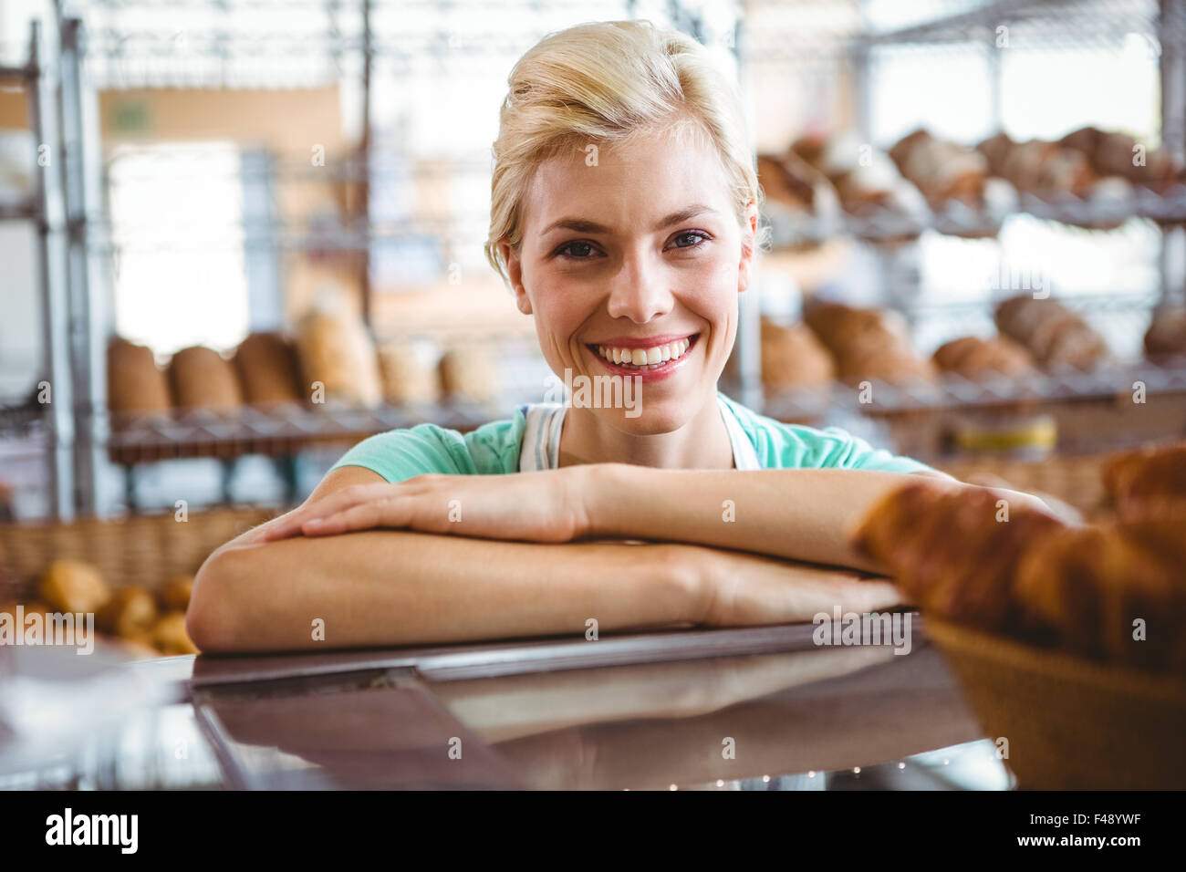 Smiling waitress posing next basket of bread Stock Photo - Alamy
