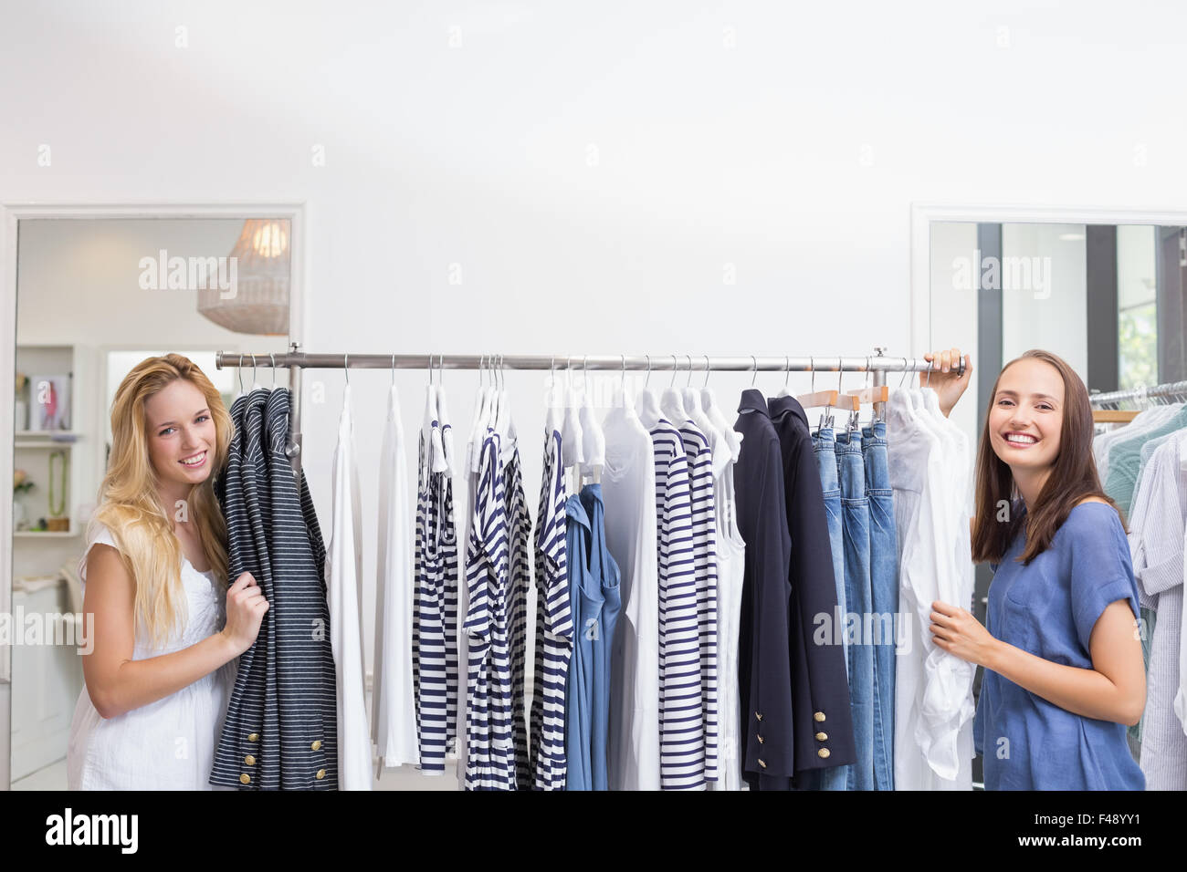 Smiling friends looking at the camera Stock Photo - Alamy