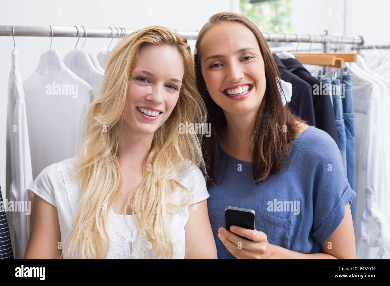 Smiling friends looking at the camera Stock Photo - Alamy