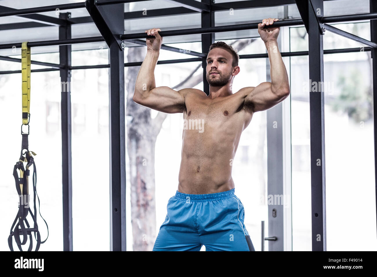 Muscular man doing pull up exercises Stock Photo - Alamy