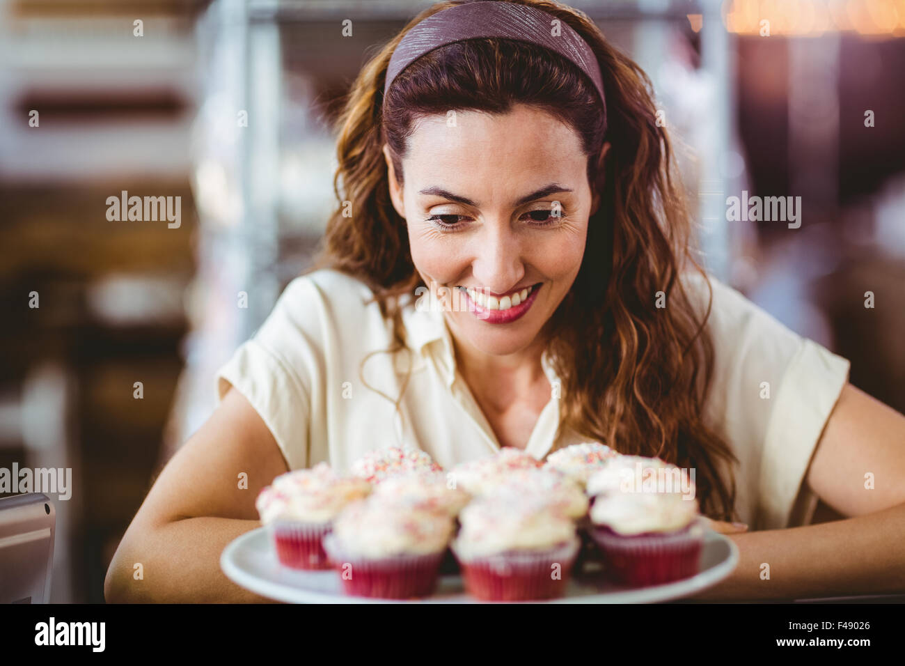 Pretty brunette looking at cakes Stock Photo - Alamy