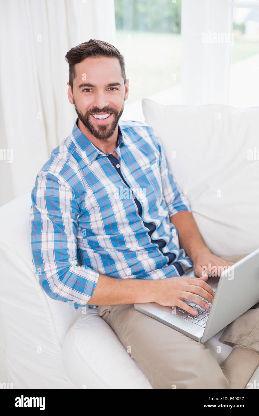 Smiling handsome man using a laptop Stock Photo - Alamy