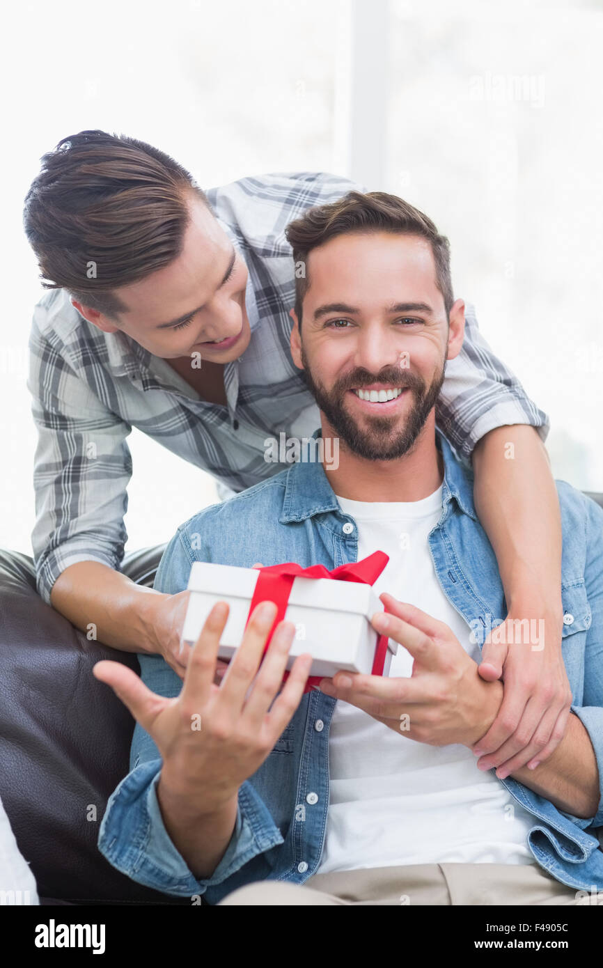 Happy homosexual couple men receiving a gift Stock Photo - Alamy