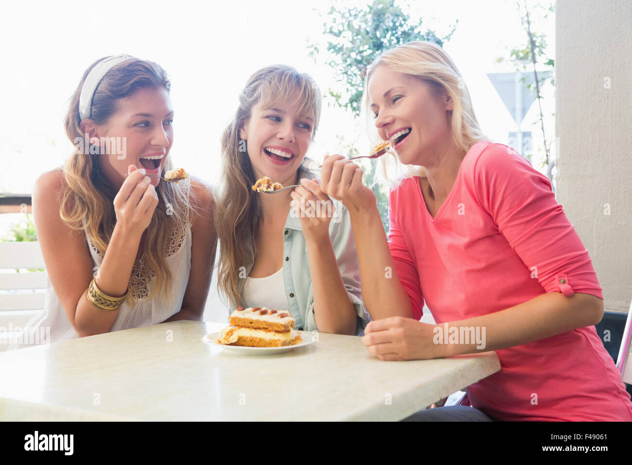Happy friends having a cake Stock Photo - Alamy