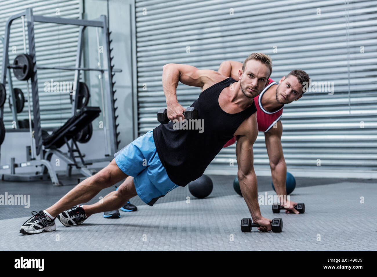 Muscular men doing a side plank Stock Photo - Alamy