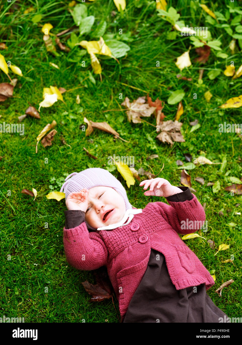 A crying little girl in the autumn leaves, Sweden Stock Photo - Alamy