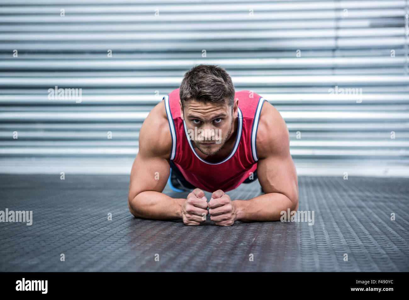 Portrait of muscular man in plank position Stock Photo - Alamy