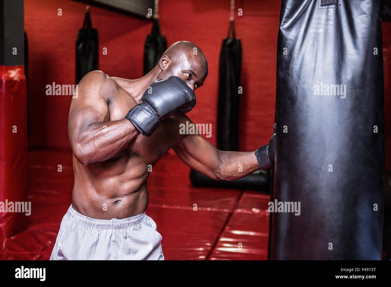 Young Bodybuilder boxing a bag Stock Photo - Alamy