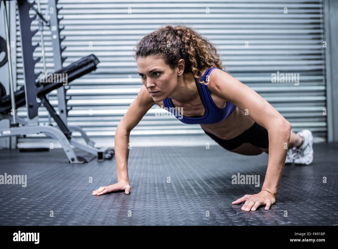 Muscular woman doing push-ups Stock Photo - Alamy