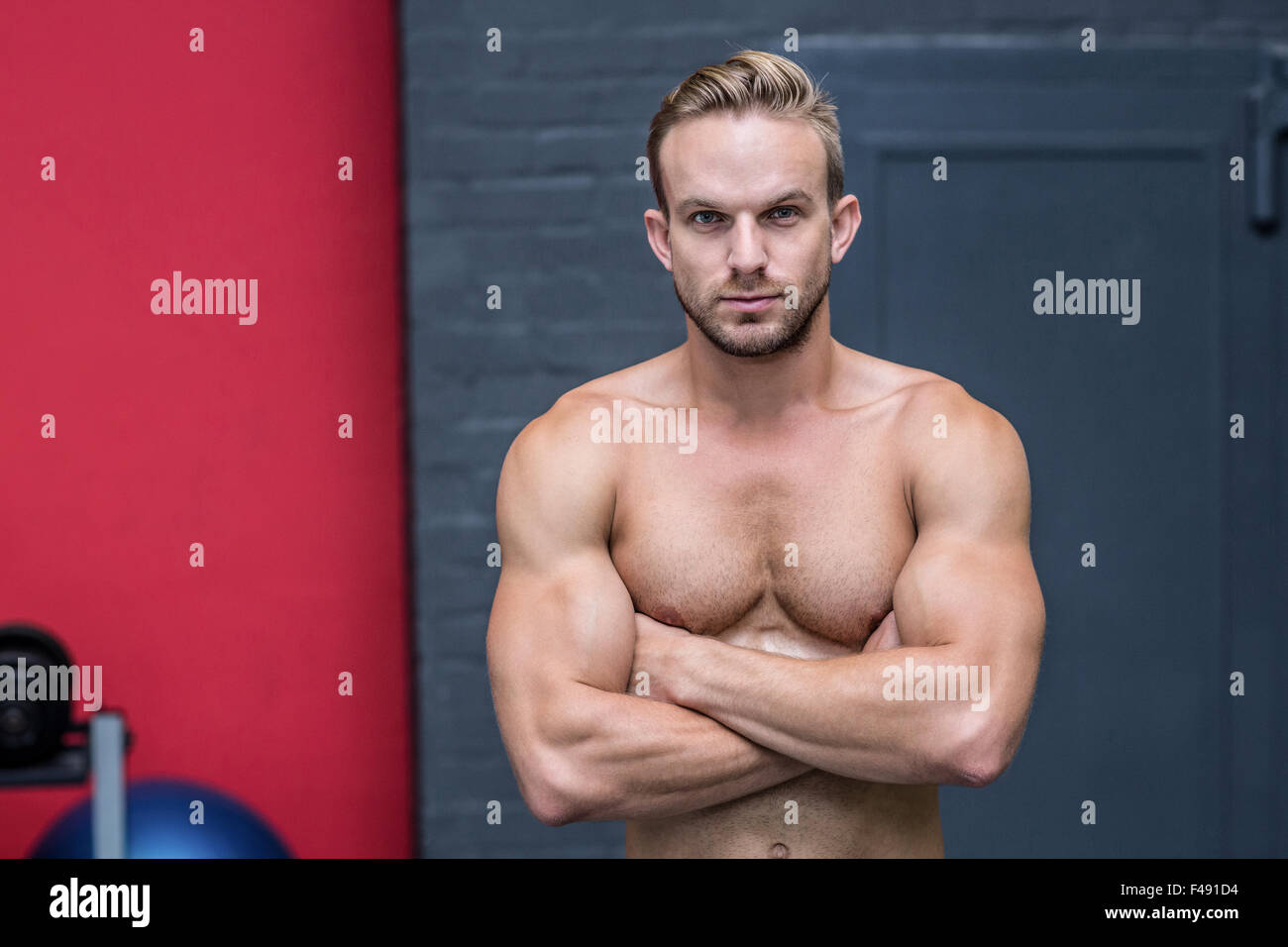 Muscular man with arms crossed Stock Photo - Alamy