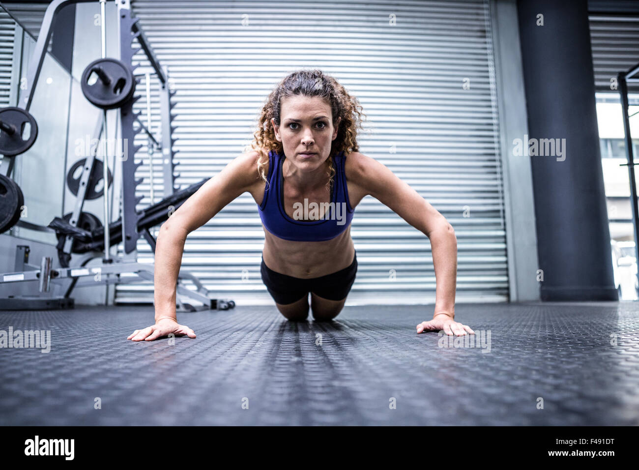 Muscular woman doing push-ups Stock Photo - Alamy