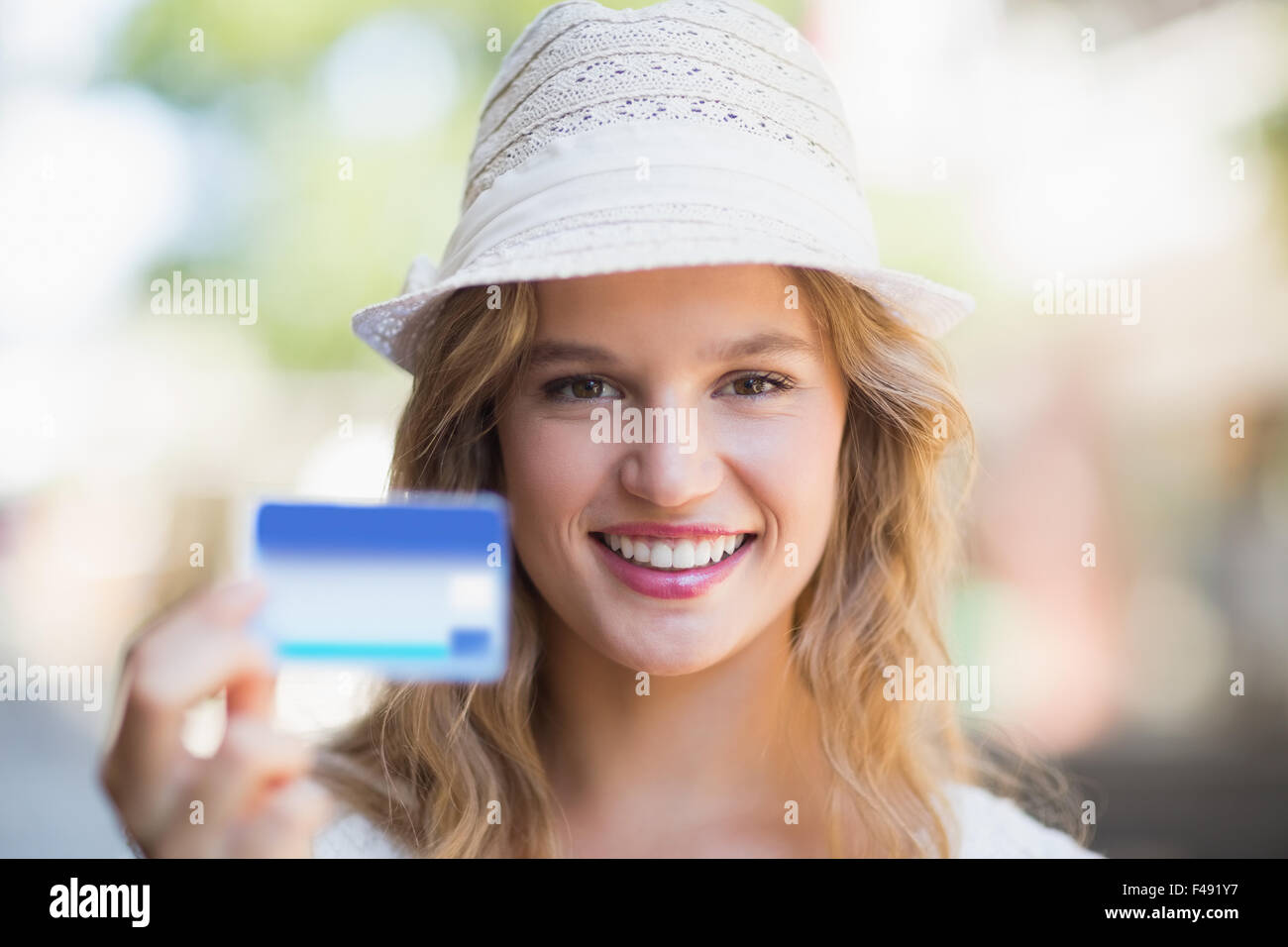 Blonde woman showing credit card hi-res stock photography and images ...