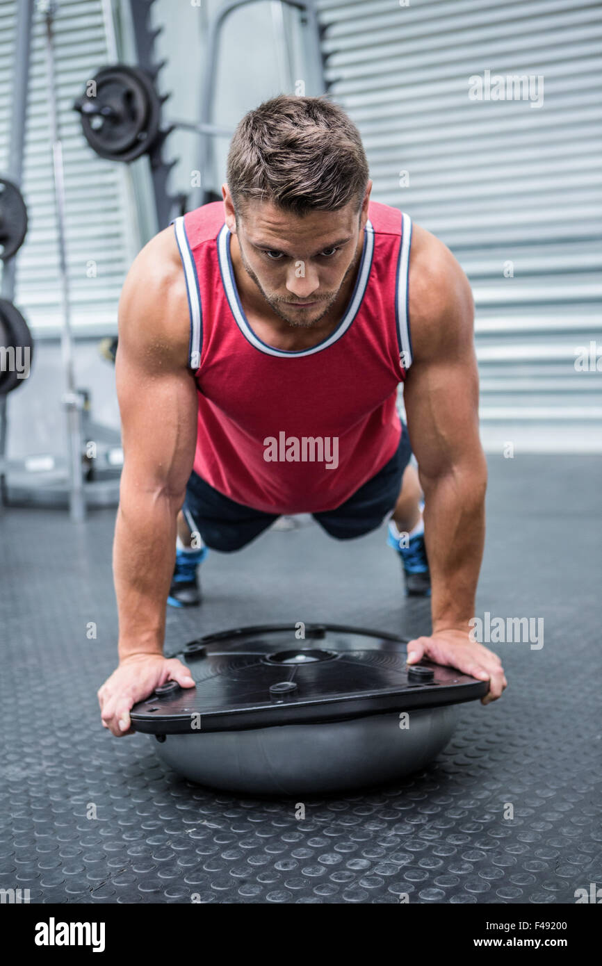 Muscular man using bosu ball Stock Photo - Alamy