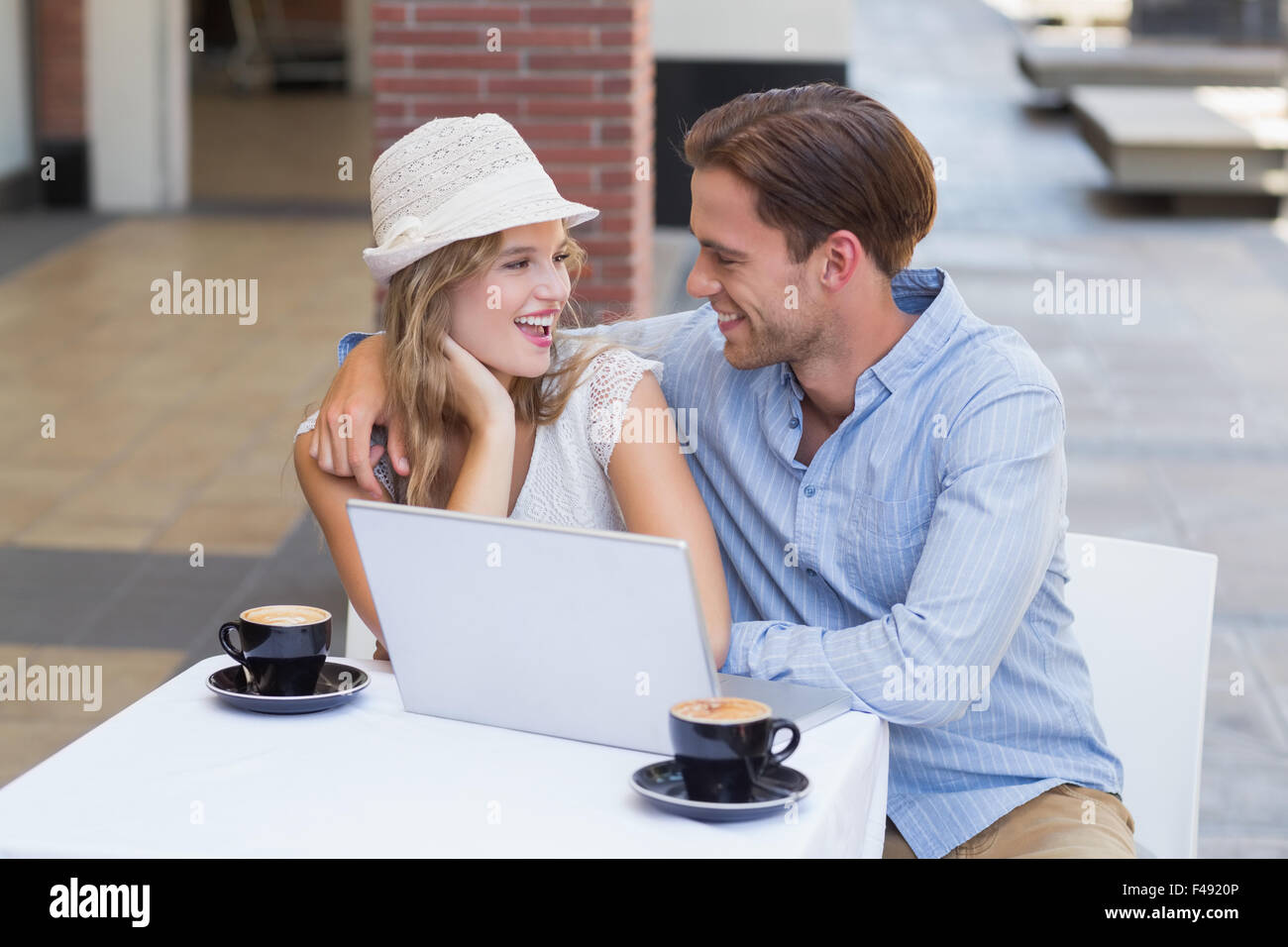 Smiling cute couple discussing together Stock Photo - Alamy