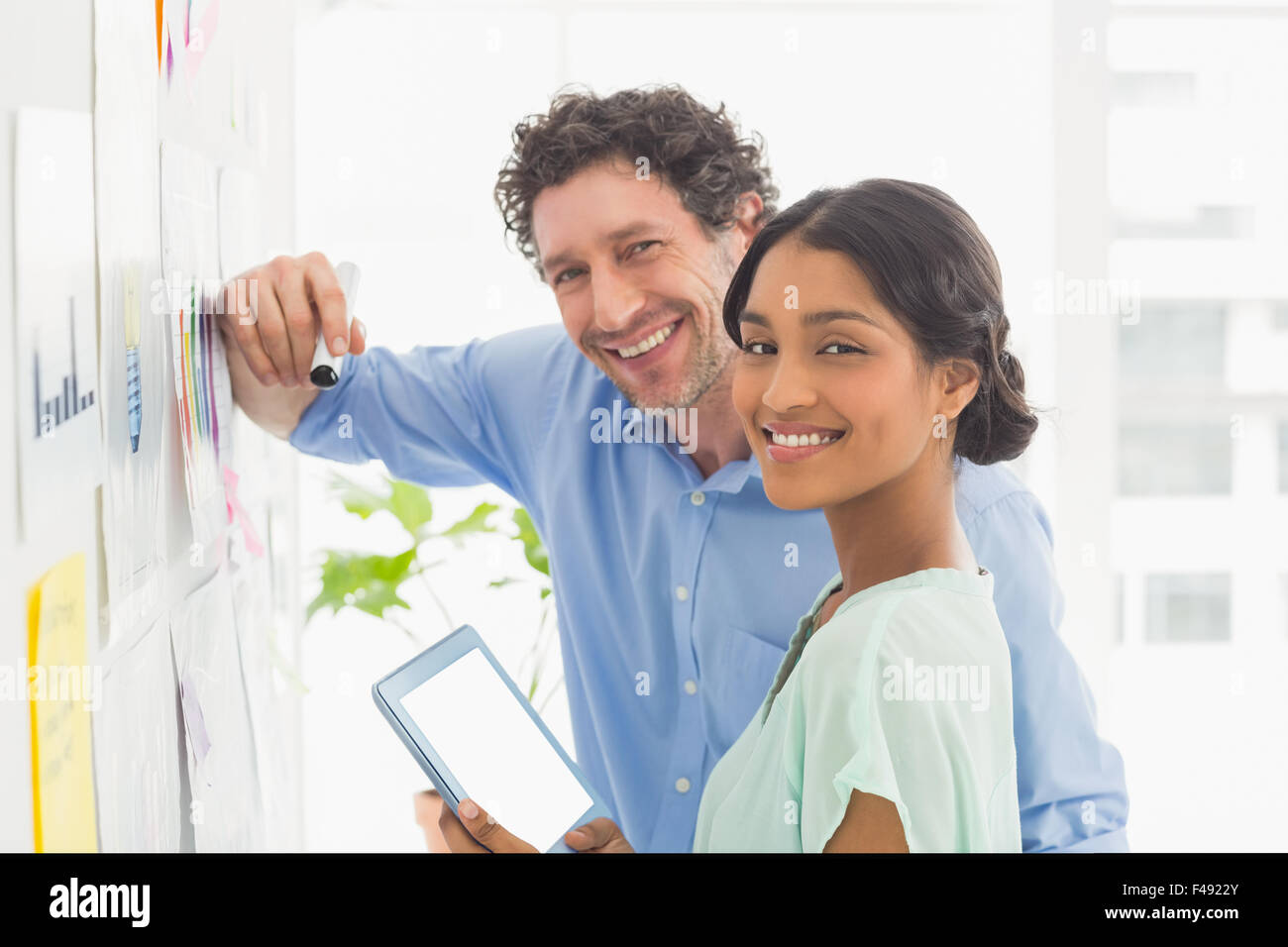 Business team analyzing charts together Stock Photo - Alamy Business team analyzing charts together Stock Photo - Alamy