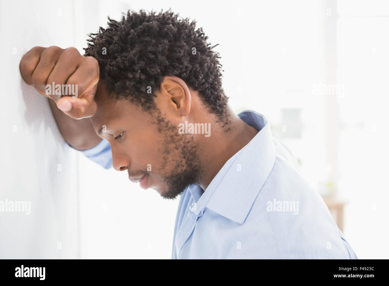 Thoughtful businessman looking down Stock Photo - Alamy
