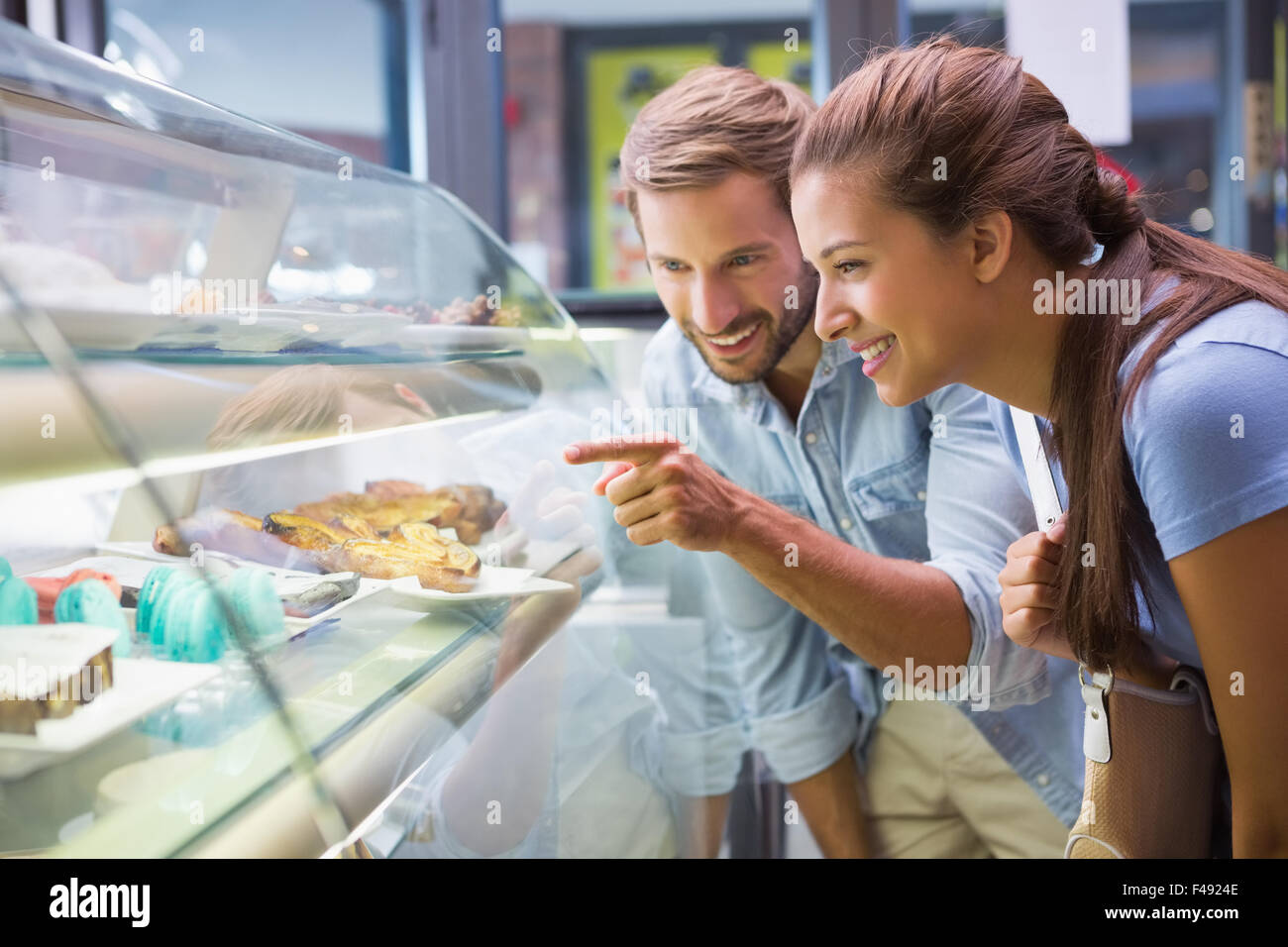 Young happy couple choosing cake Stock Photo - Alamy