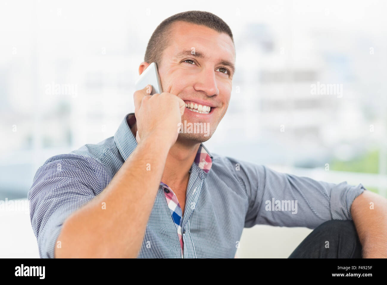 Smiling businessman laughing on the phone Stock Photo - Alamy
