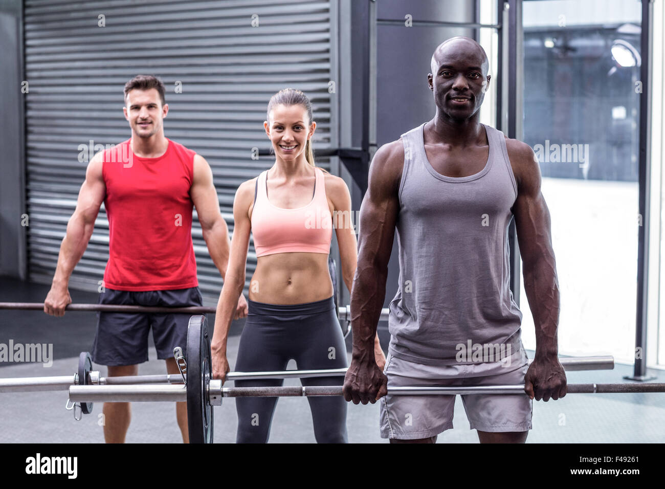 Three muscular athletes lifting barbells Stock Photo - Alamy