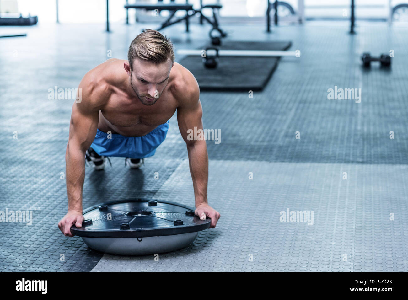 Muscular man doing bosu ball exercises Stock Photo - Alamy