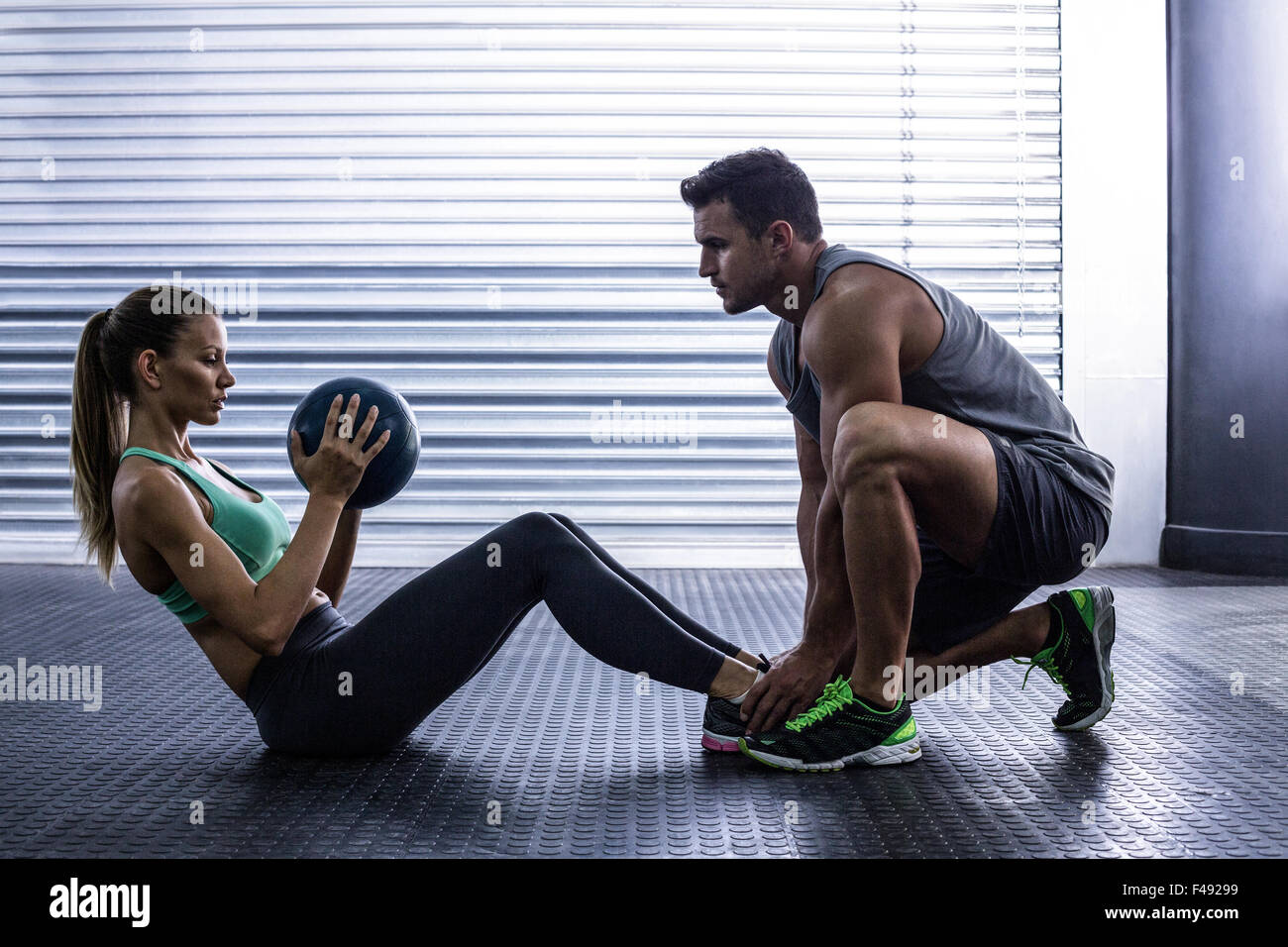 Muscular couple doing abdominal ball exercise Stock Photo - Alamy