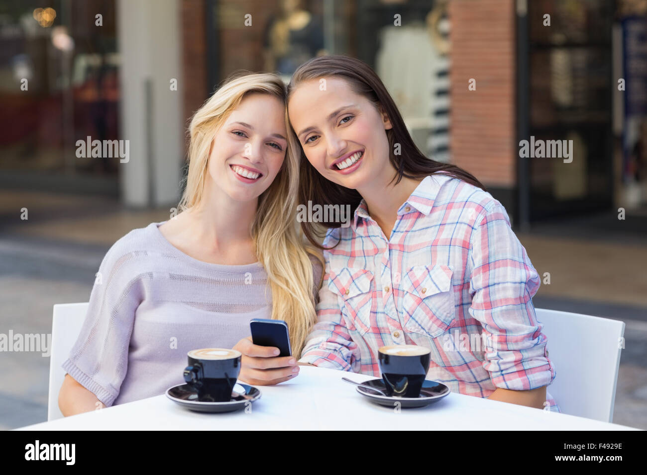 Happy women friends smiling at camera Stock Photo - Alamy
