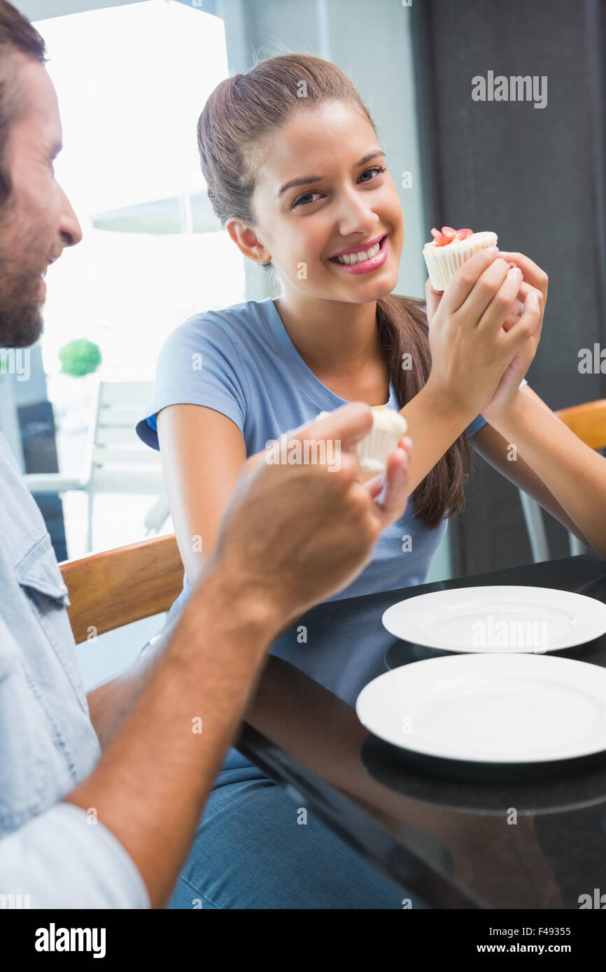 Young happy couple eating cake Stock Photo - Alamy
