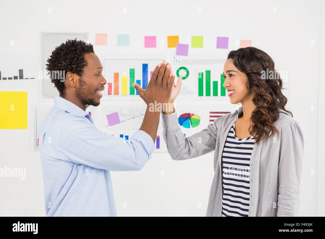 Young smiling business people clapping hands Stock Photo - Alamy