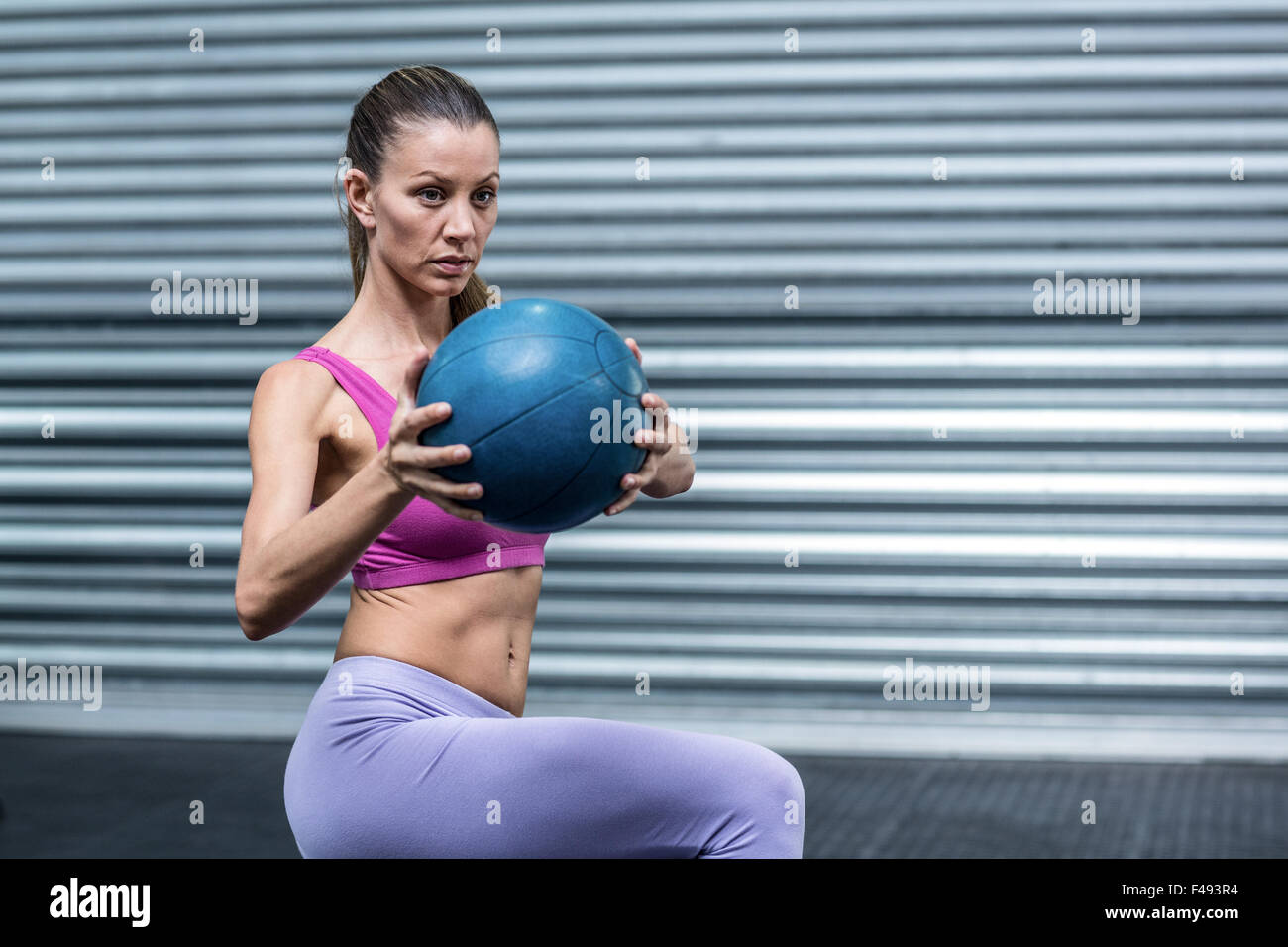 A muscular woman doing ball exercises Stock Photo - Alamy