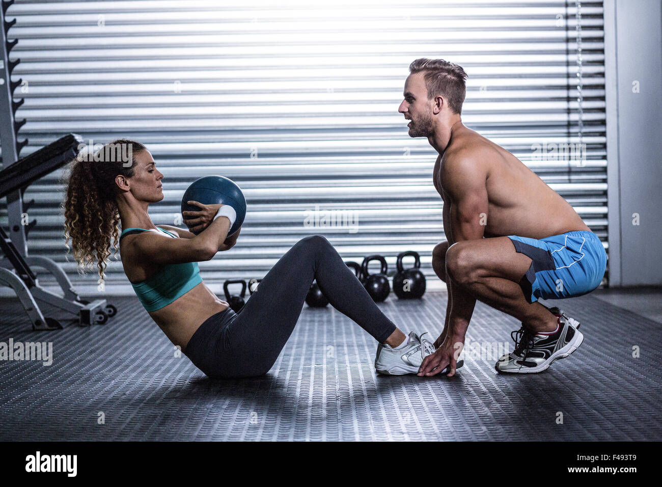 Muscular couple doing abdominal ball exercise Stock Photo - Alamy